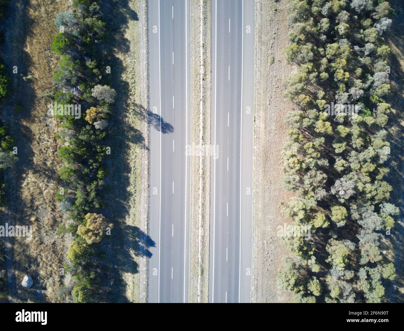 Australia highway aerial view showing highway median and forest trees ...