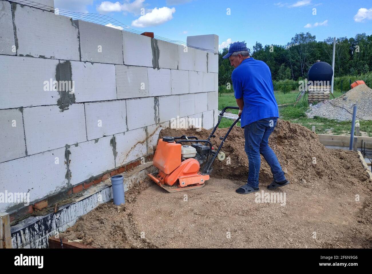 Construction work on the construction site, soil compaction with a ...