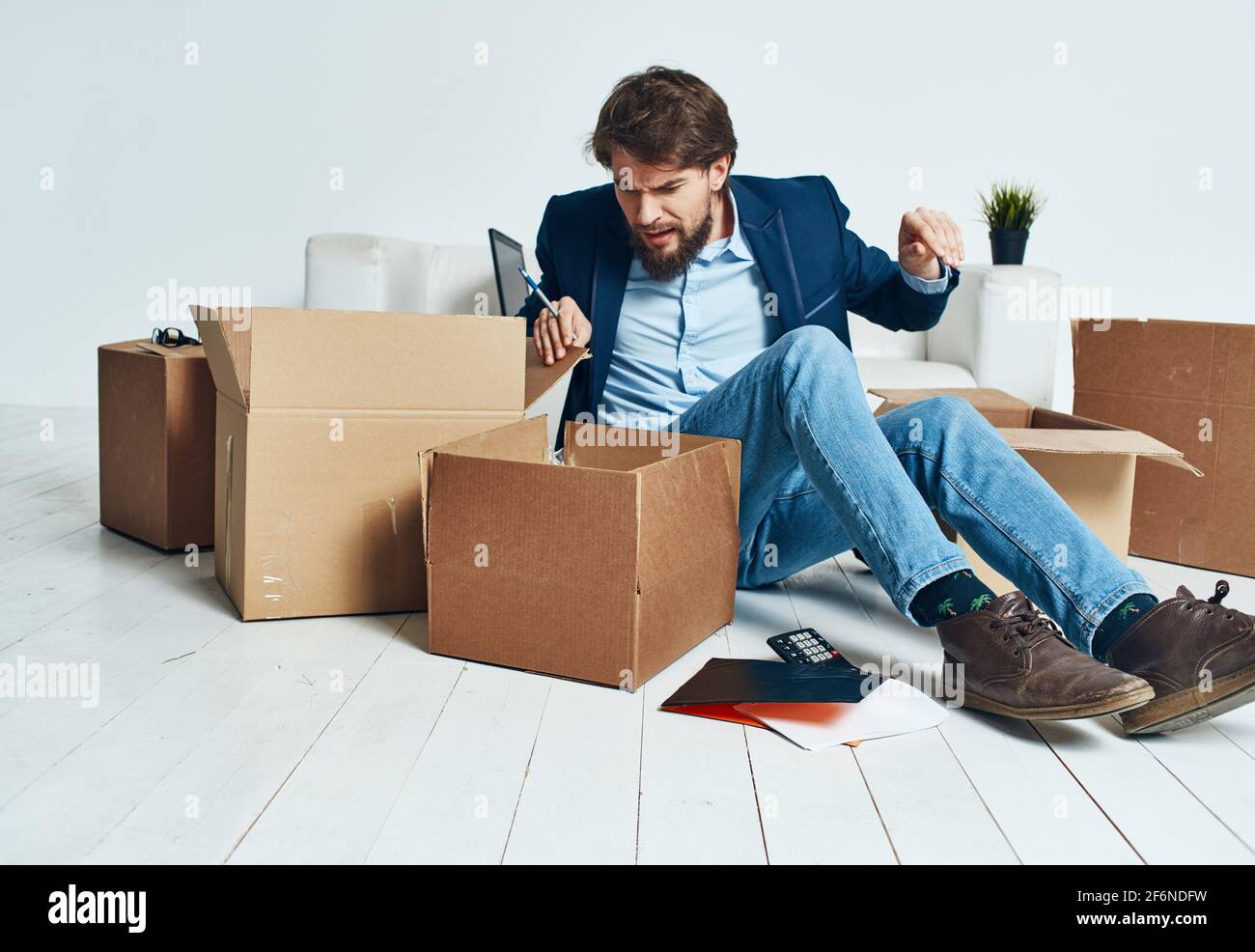 Business man picking up cardboard boxes and moving to a new place ...