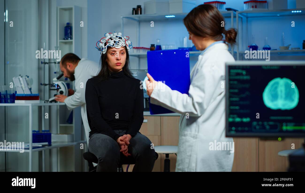 Neuroscience doctor holding clipboard showing treatment against brain ...