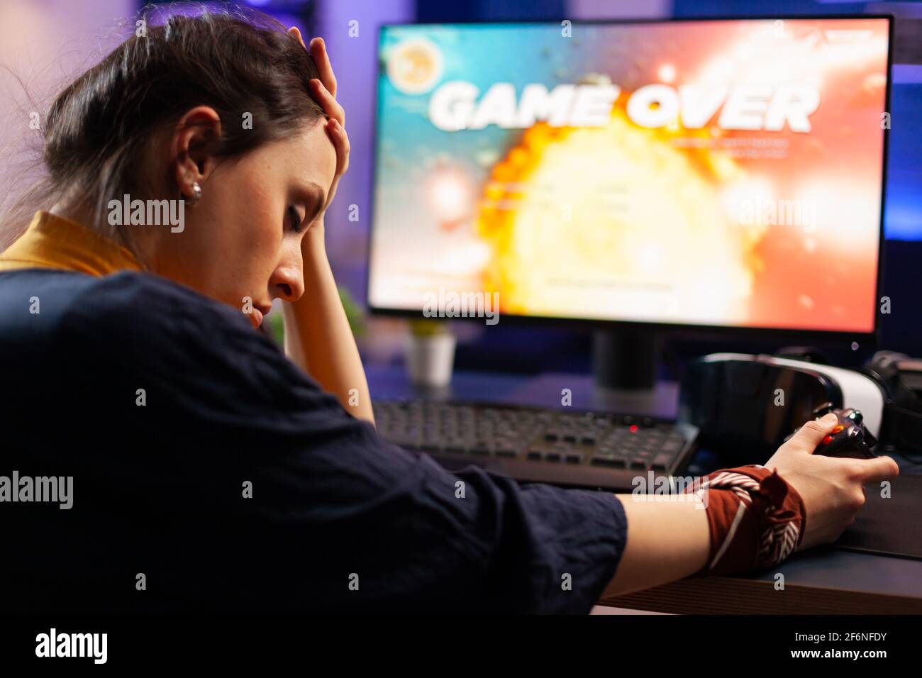 Pro videogames keeping his head on hand after losing space shooter game ...