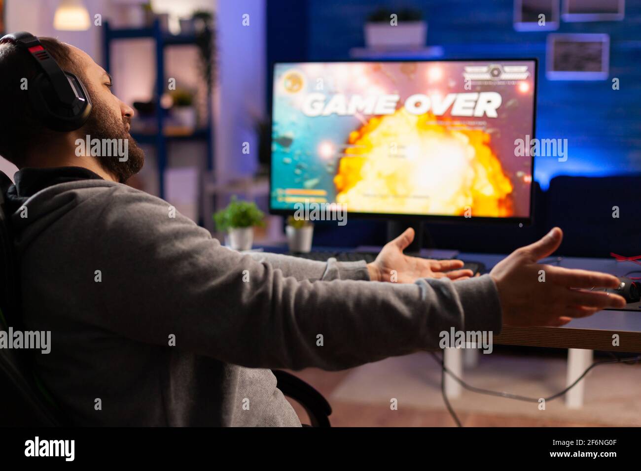 Game over for gamer playing videogames on computer during night time in ...