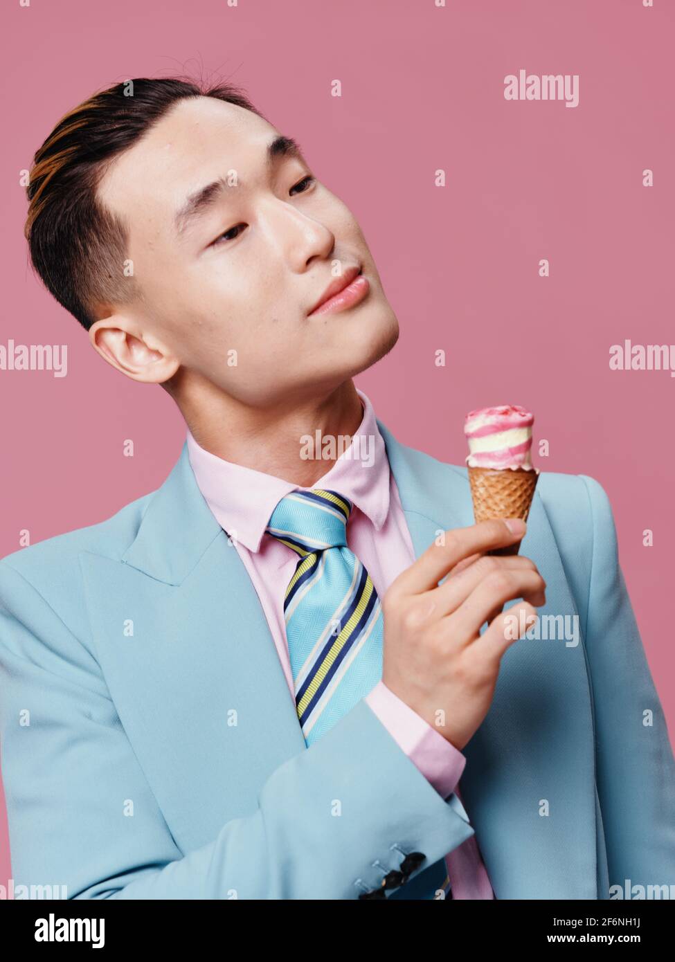 Cute man in blue suit ice cream in hands fun pink background Stock ...