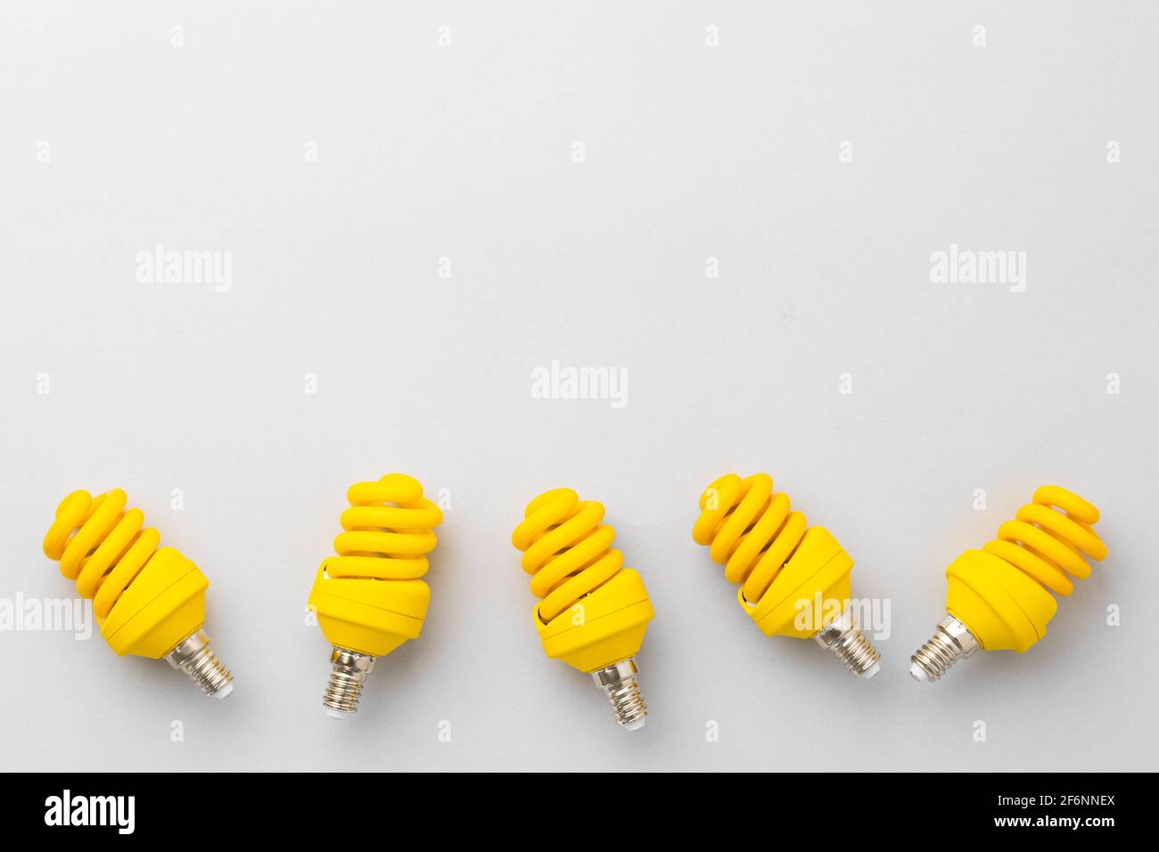 Light bulb on light grey paper background Stock Photo - Alamy