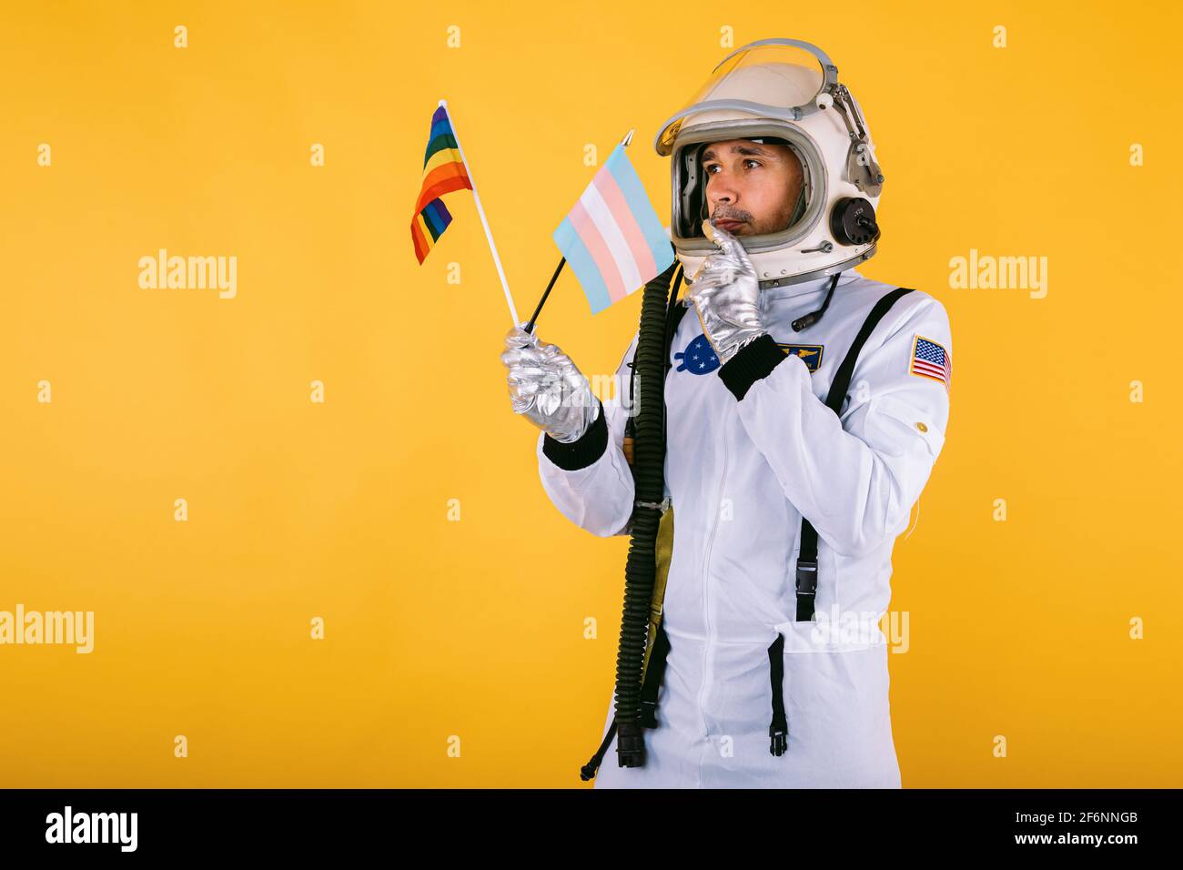 Gay transsexual male cosmonaut with serious gesture in space suit and ...