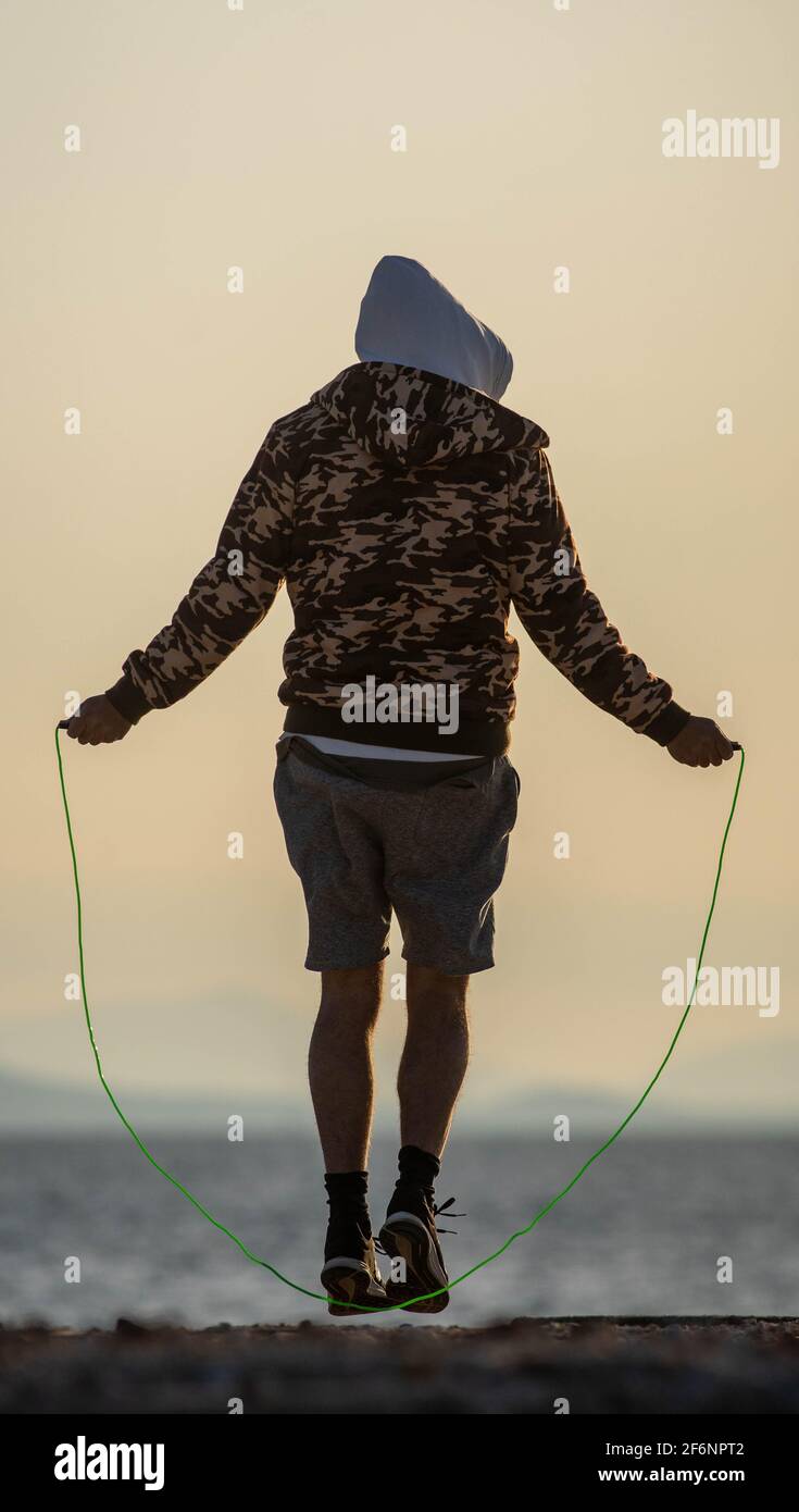 A young guy jumping using a rope,ath Glyfada,Greece Stock Photo - Alamy