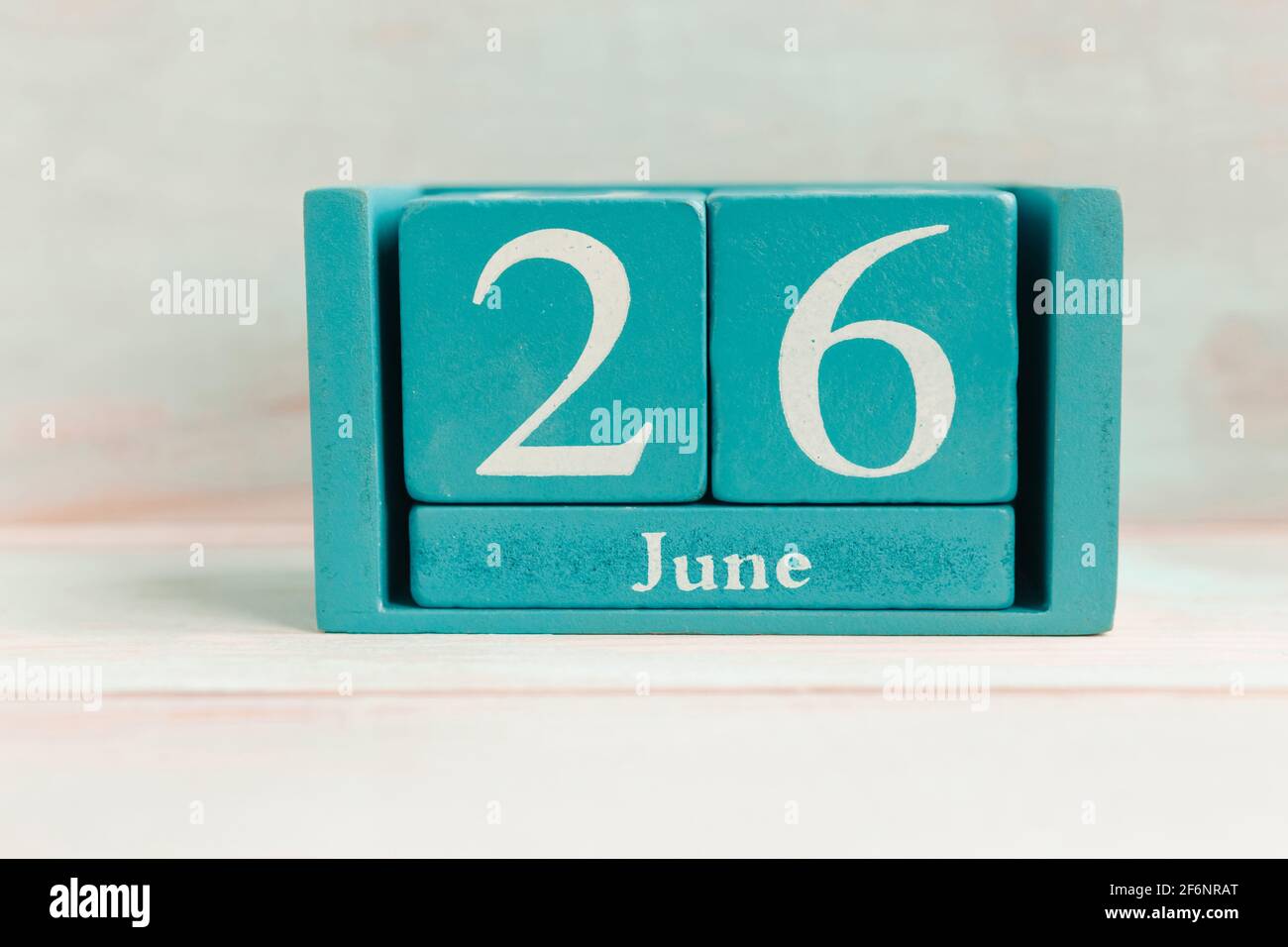 June 26. Blue cube calendar with month date isolated on wooden ...