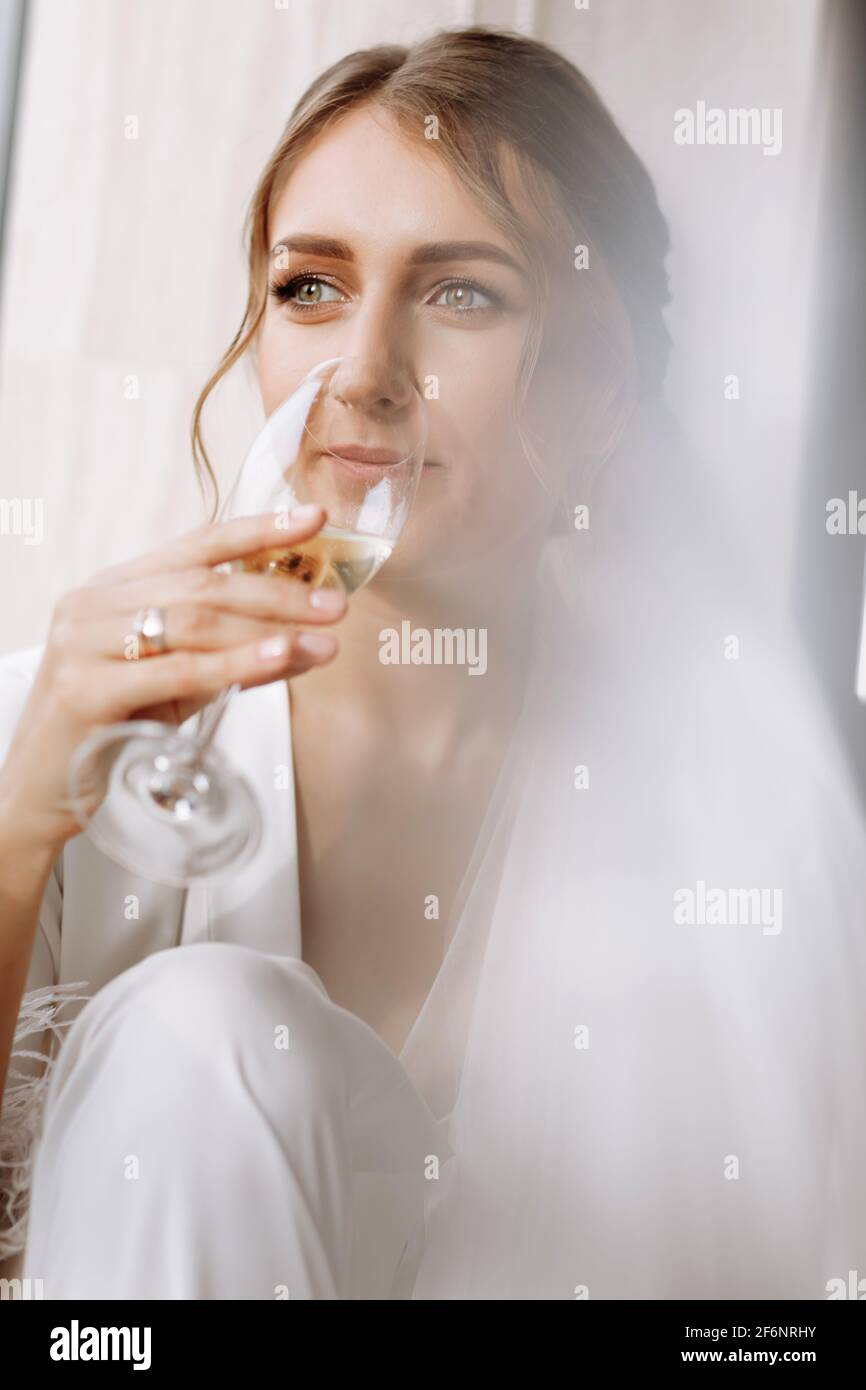 Bride s morning. Bride drinking champagne in the peignoir. young woman ...