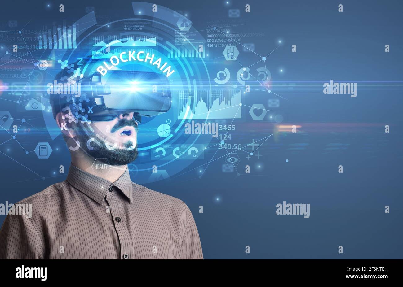 Businessman looking through VR glasses Stock Photo - Alamy