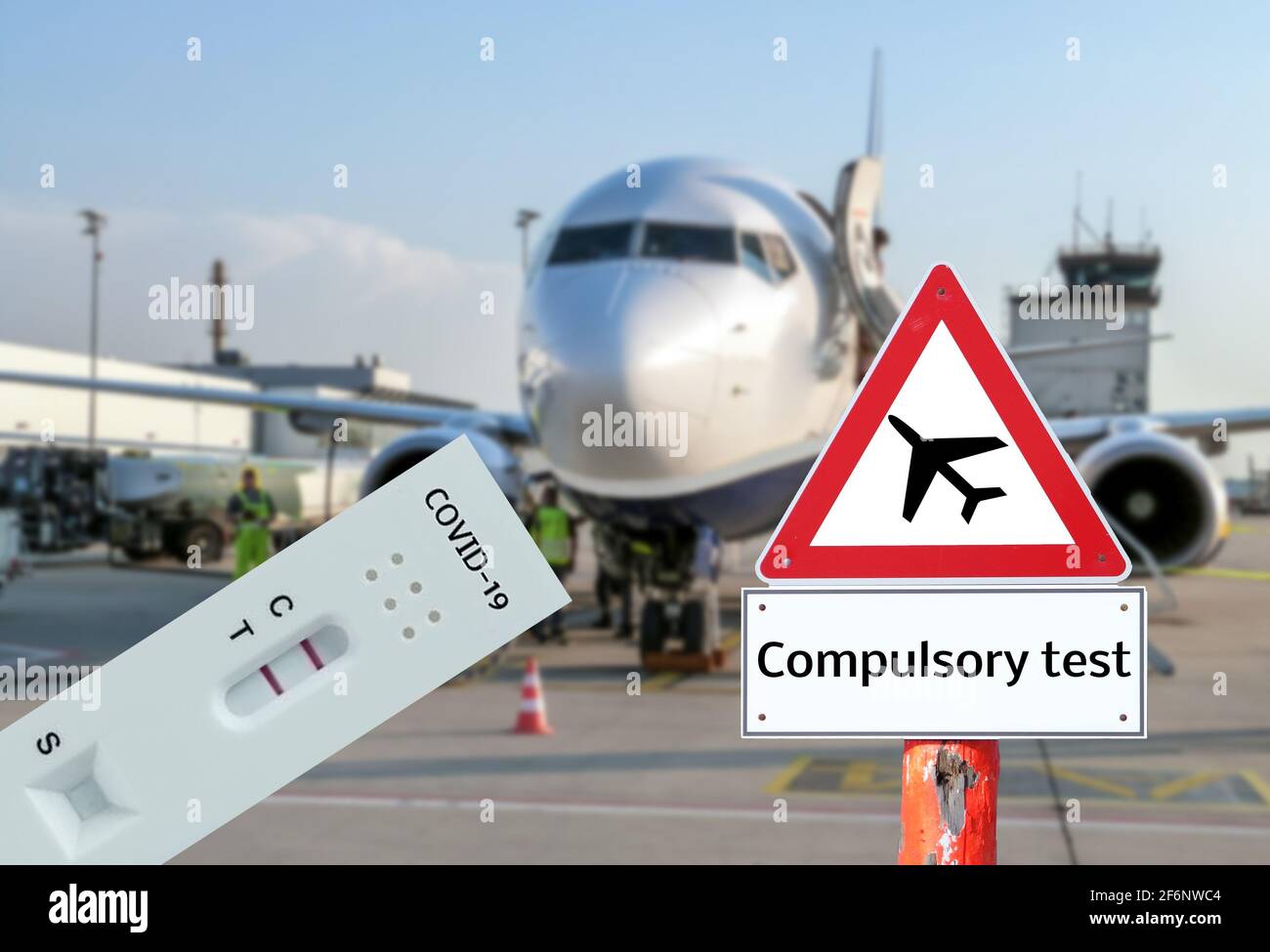 Warning sign Compulsory test Corona at the airport Stock Photo - Alamy