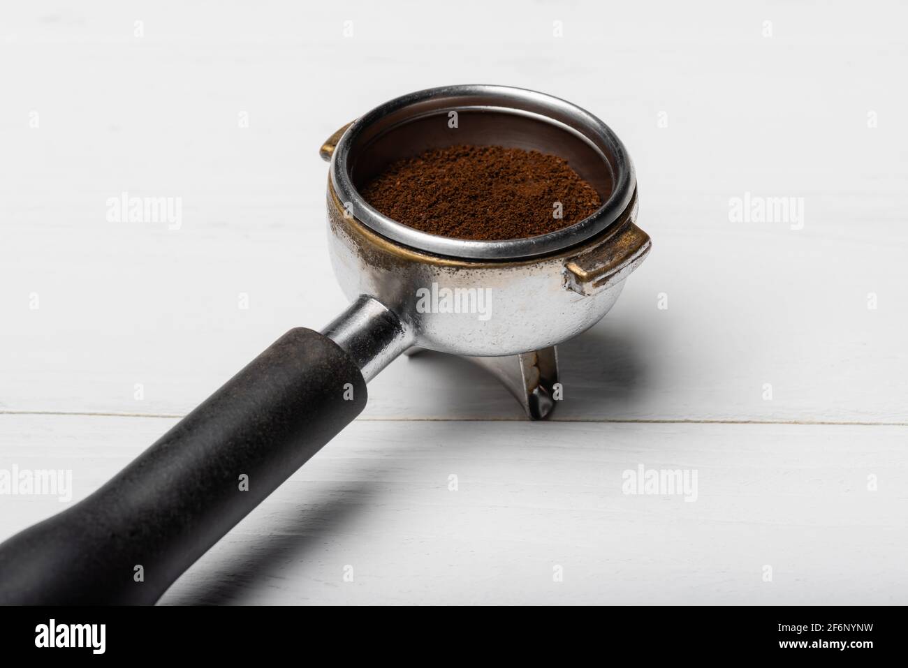 metallic portafilter with fresh ground coffee on white Stock Photo - Alamy
