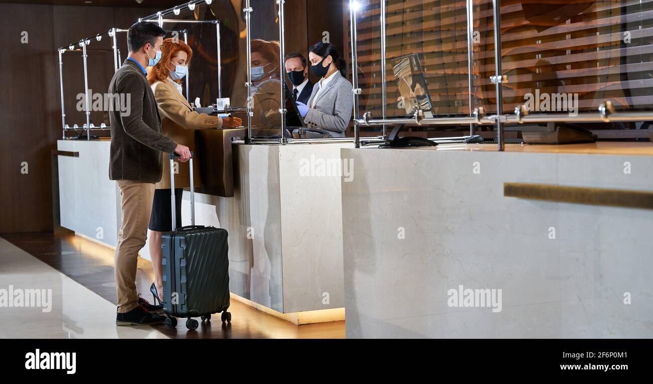 Guest Arriving With Luggage Free Photo | Hotel Bellboy Helping Guests