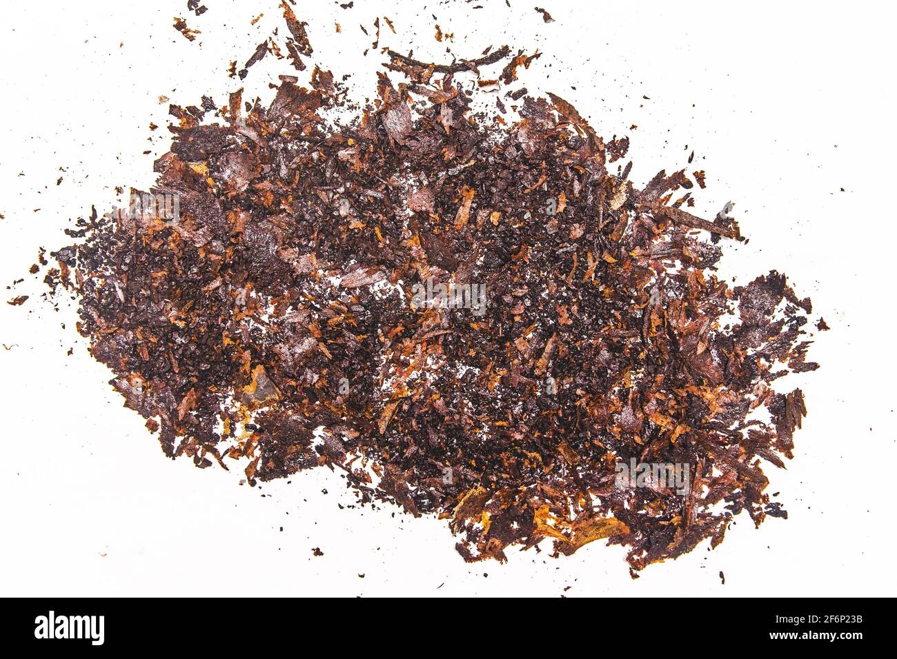 A pile of rusty, dirty old dark soot from a pan on a white background ...