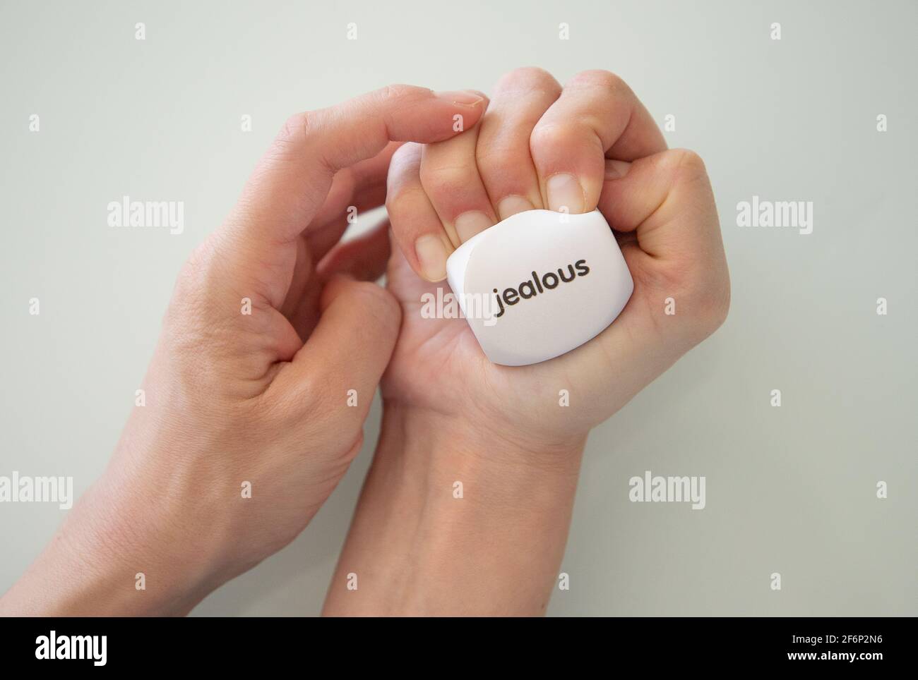 Sign jealous in hands of female Stock Photo - Alamy