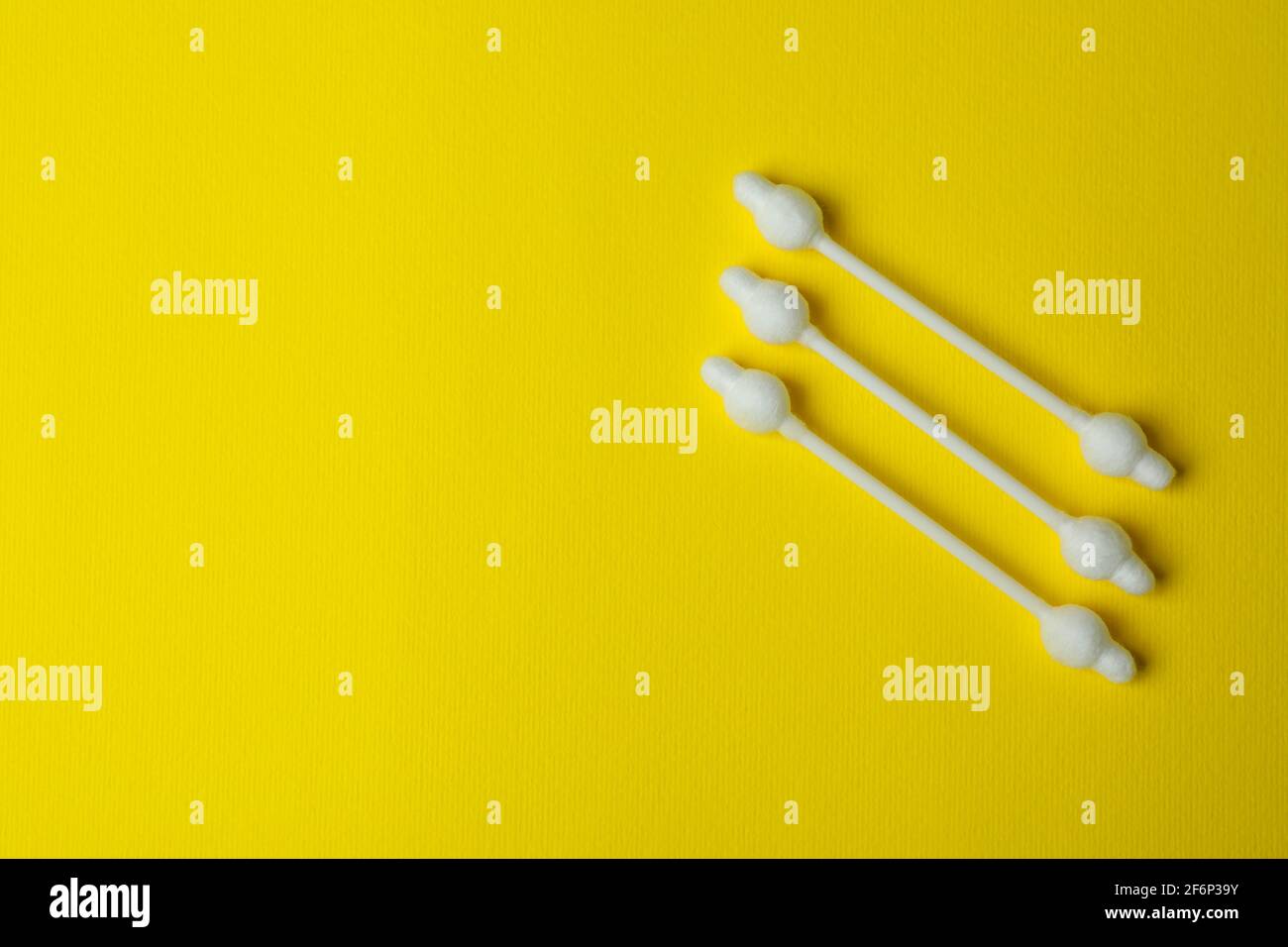 Cotton swabs on yellow background, space for text Stock Photo - Alamy