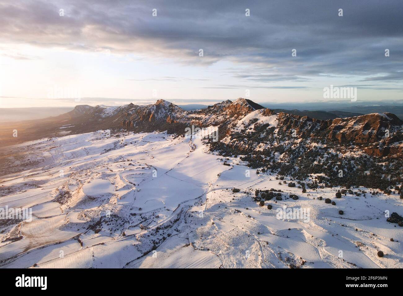 Aerial view of snow covered mountains at sunset. High quality photo ...