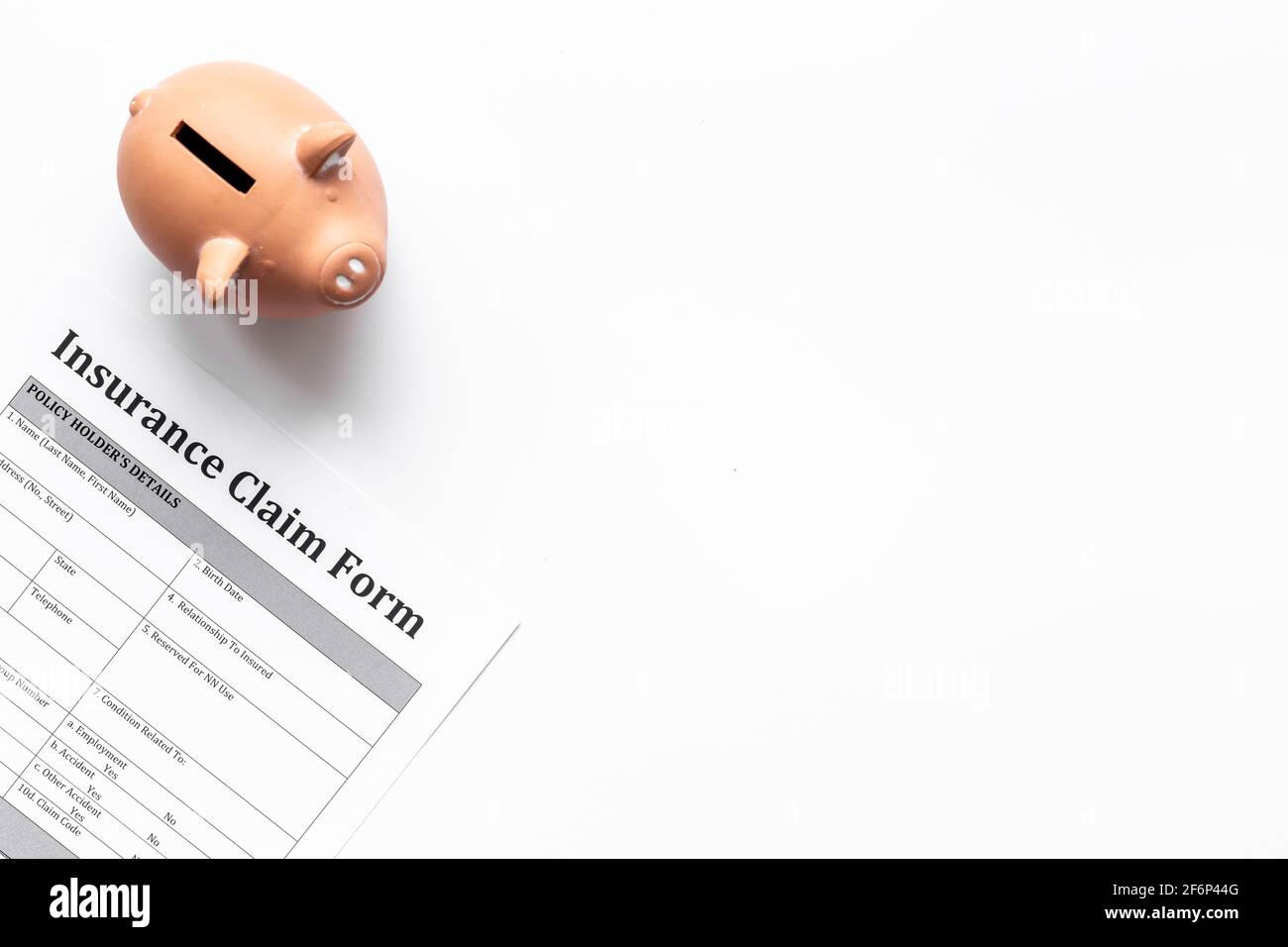 Insurance claim form with piggy bank. Top view Stock Photo - Alamy