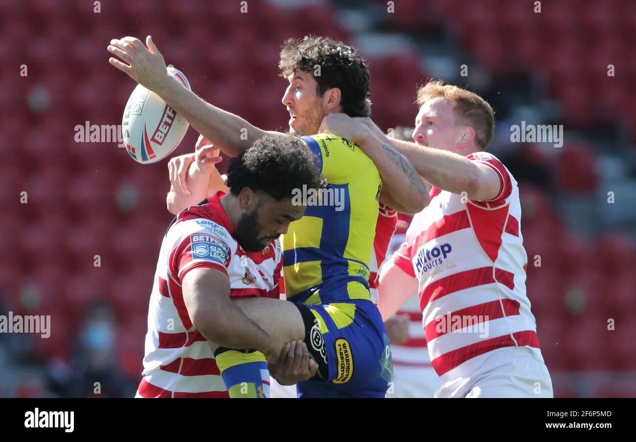 Warrington Wolves' Stefan Ratchford (centre) is tackled during the ...