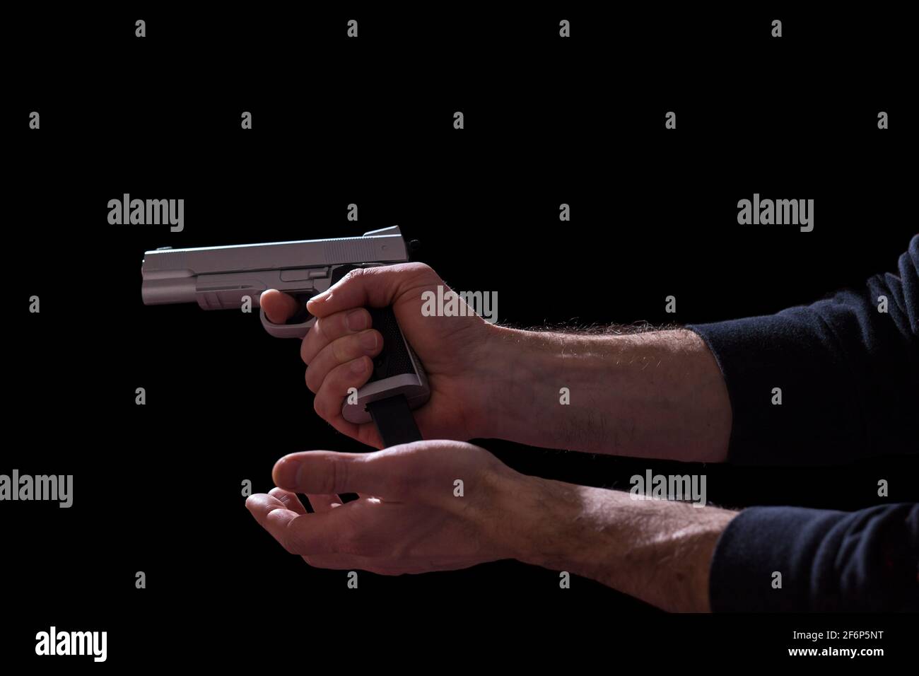 Male hands reloading gun magazine, isolated on blackbackground Stock ...