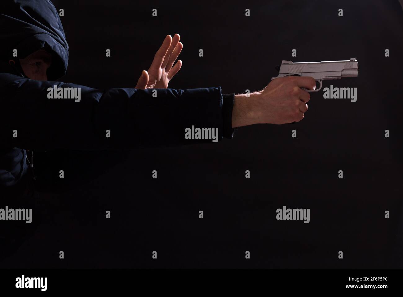 The man aim with a gun and afraid to shoot at same time, on black ...