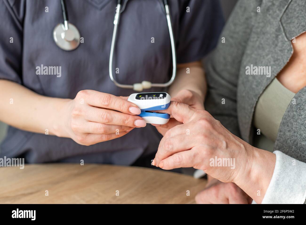 Medic and patient using finger pulse oximeter Stock Photo - Alamy
