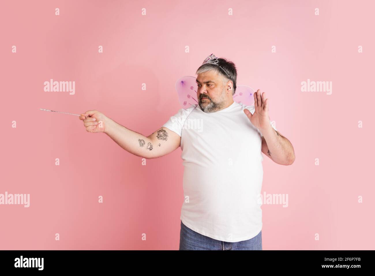 Handsome caucasian plus size male model isolated on coral pink studio ...