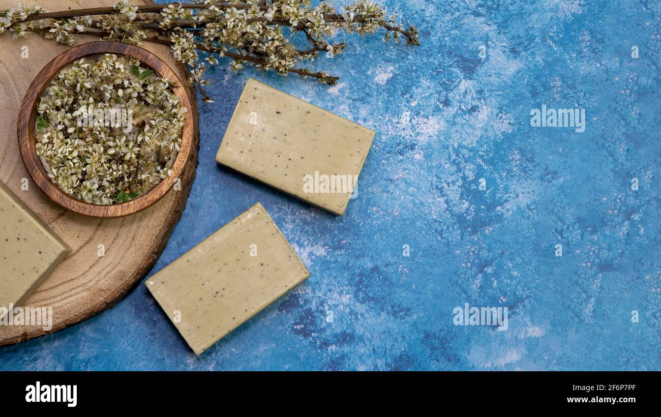 Top view, Aleppo soap and dray Laurus nobilis flower in a wooden plate ...