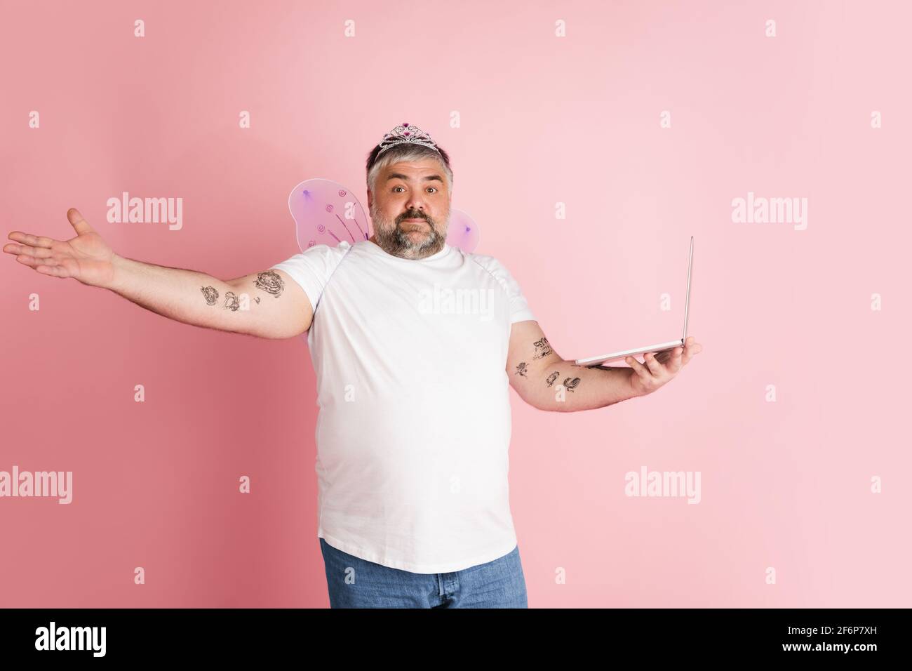 Handsome caucasian plus size male model isolated on coral pink studio ...