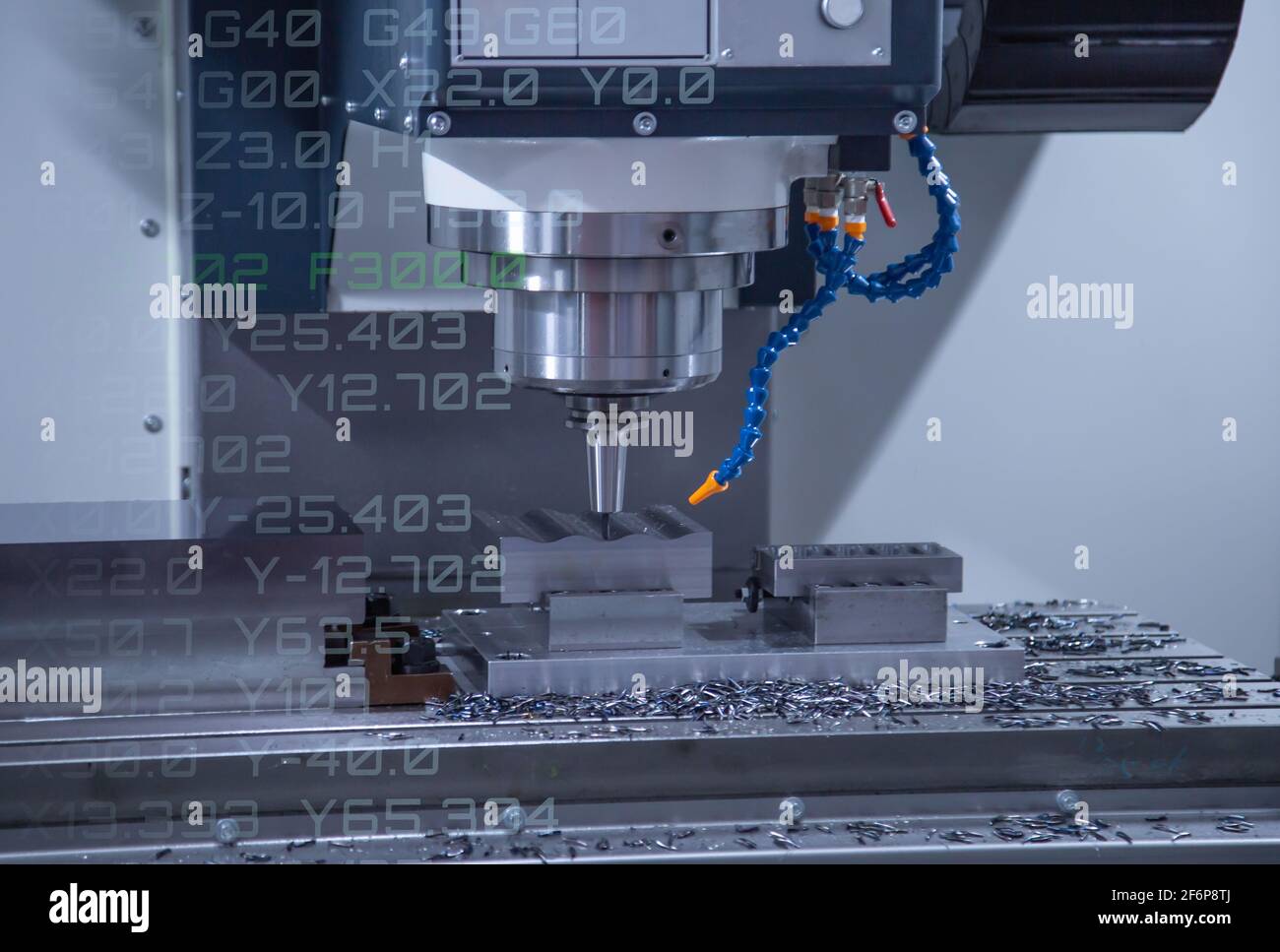 CNC milling machine cutting workpiece with coolant. CNC programming ...