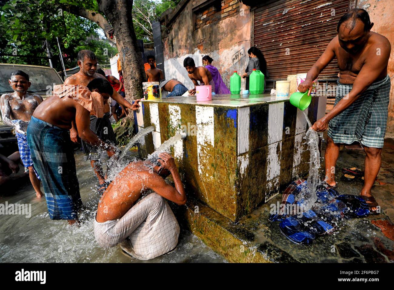 Kolkata, India. 02nd Apr, 2021. People seen taking bath from a roadside ...
