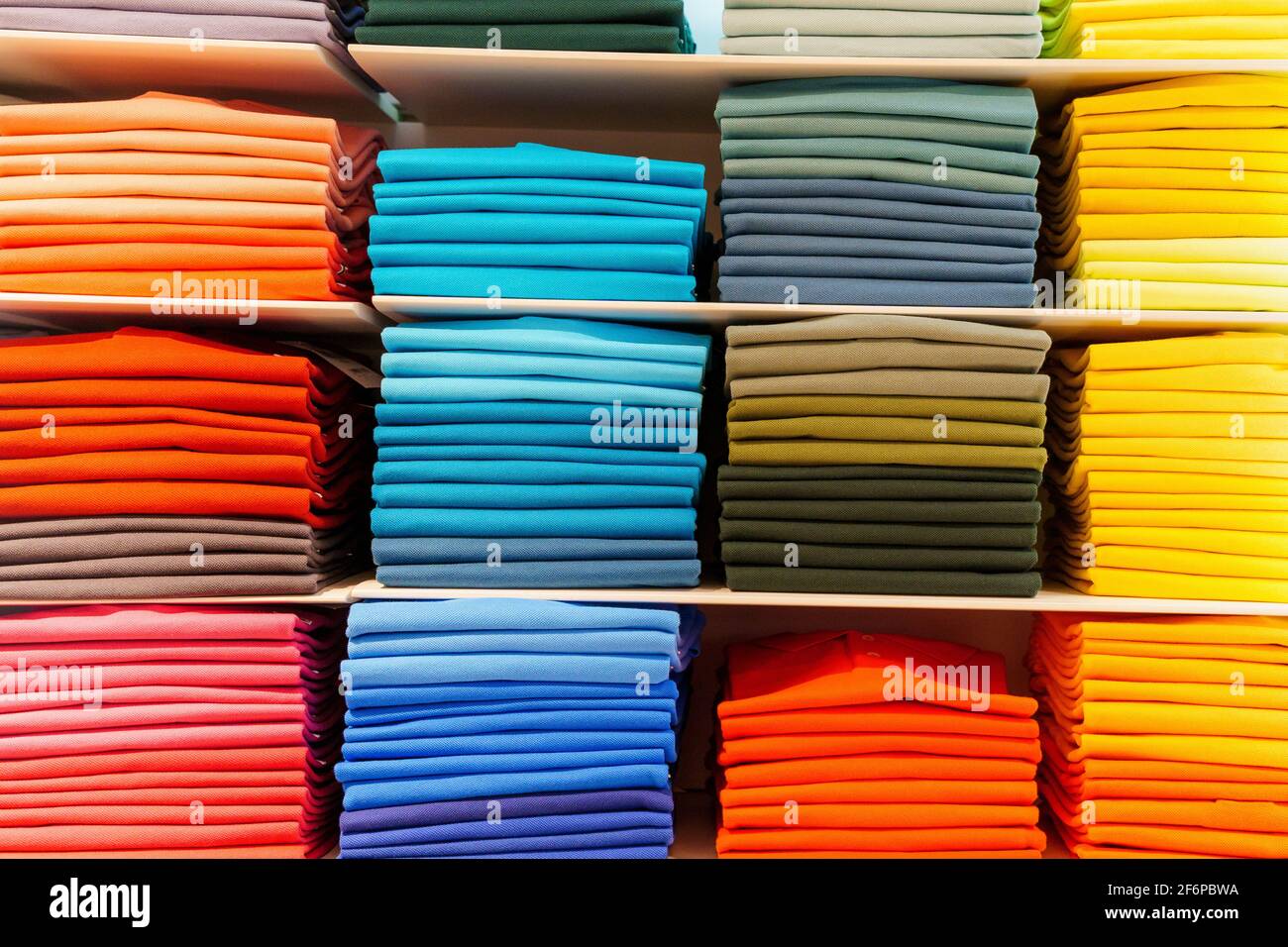 Shirts folded and sorted by colour ranges. Market place Stock Photo - Alamy