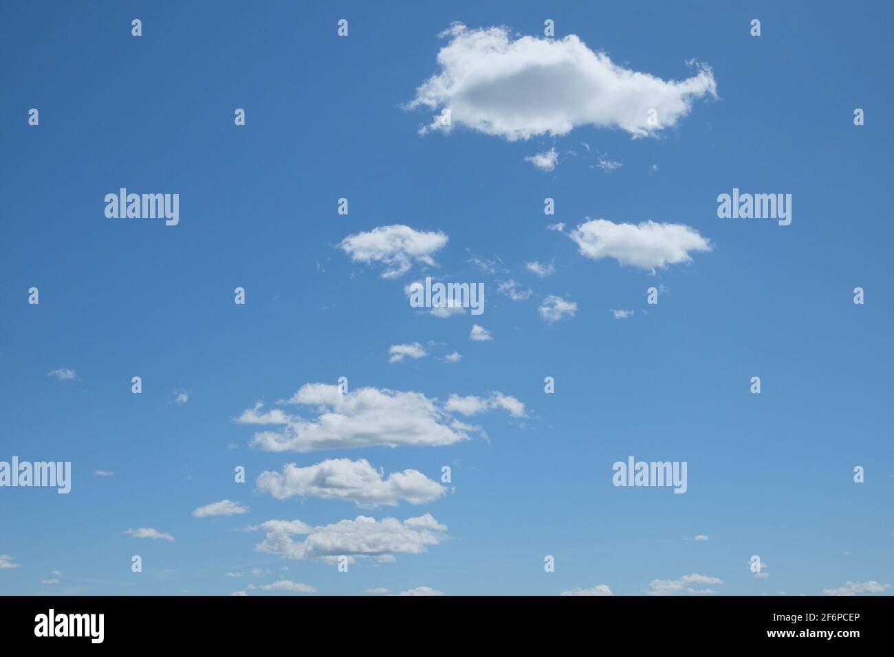 Small cumulus clouds against the blue sky. Background Stock Photo - Alamy