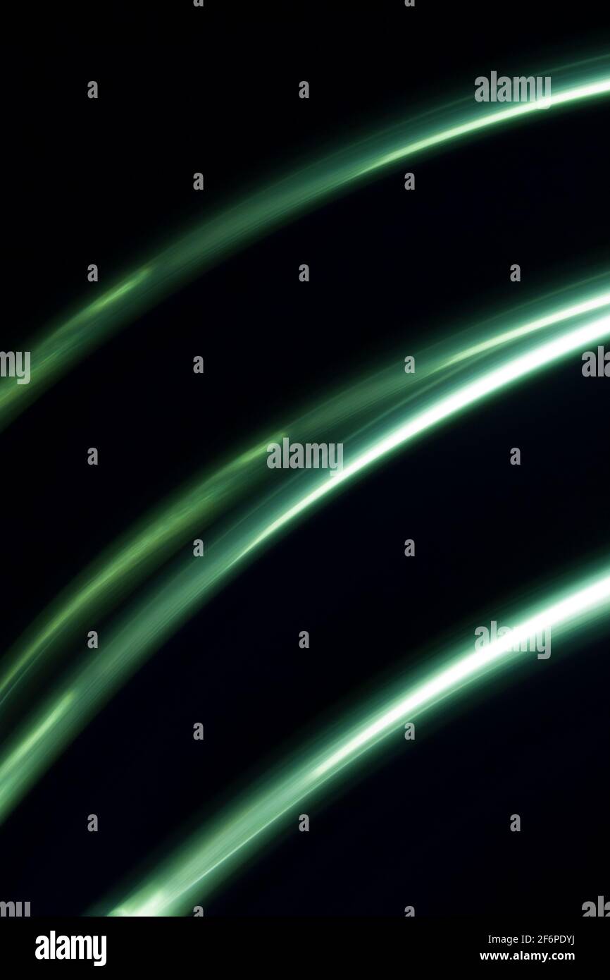 green light lines on a black background Stock Photo - Alamy