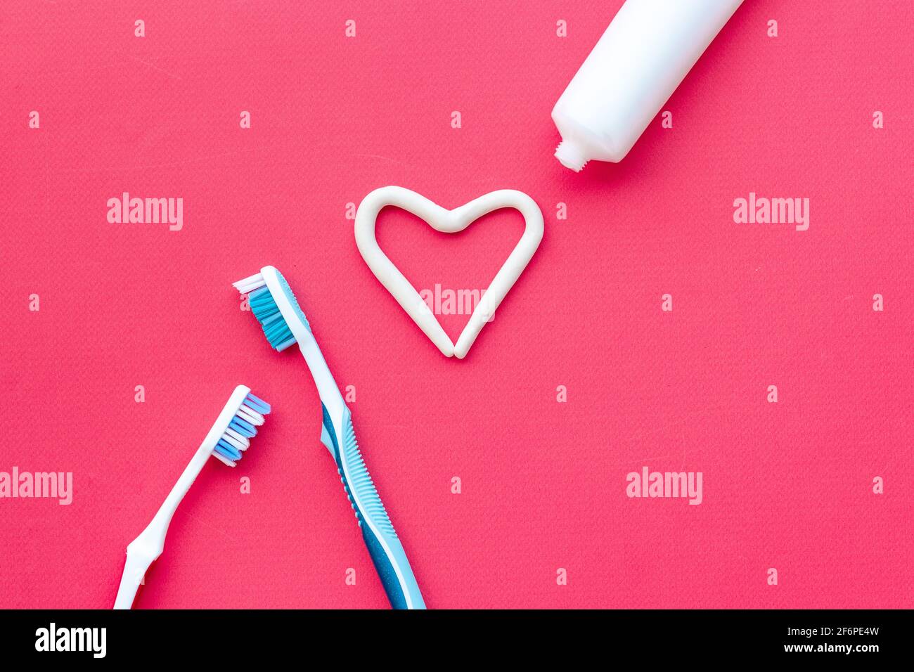 Teeth hygiene. Toothbrush with heart shape made of toothpaste, top view ...