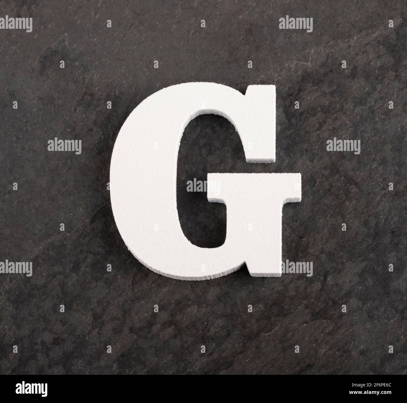 Letter G from blank alphabet on gray background Stock Photo - Alamy