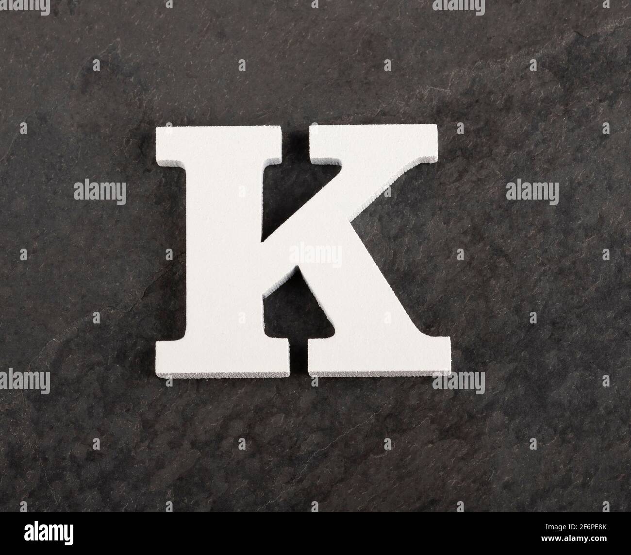 Letter K from blank alphabet on gray background Stock Photo - Alamy