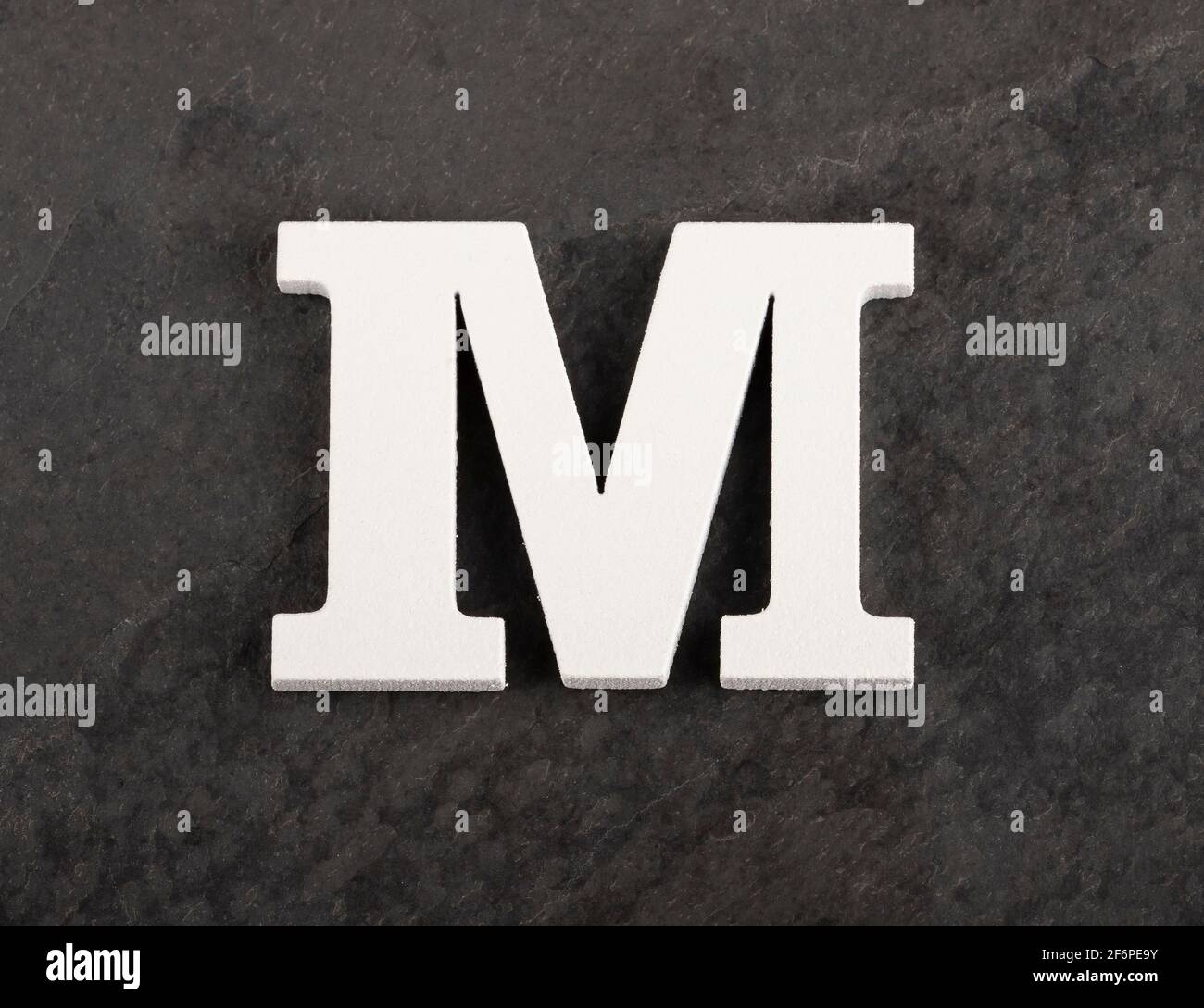Letter M from blank alphabet on gray background Stock Photo - Alamy