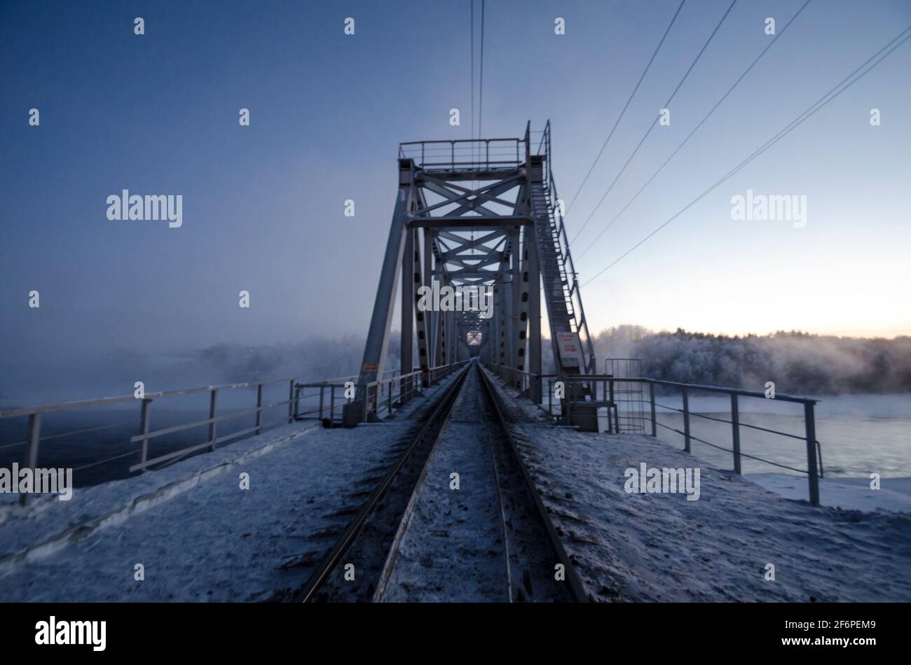 Beautiful iron bridge on the background of sunset and fog Stock Photo ...