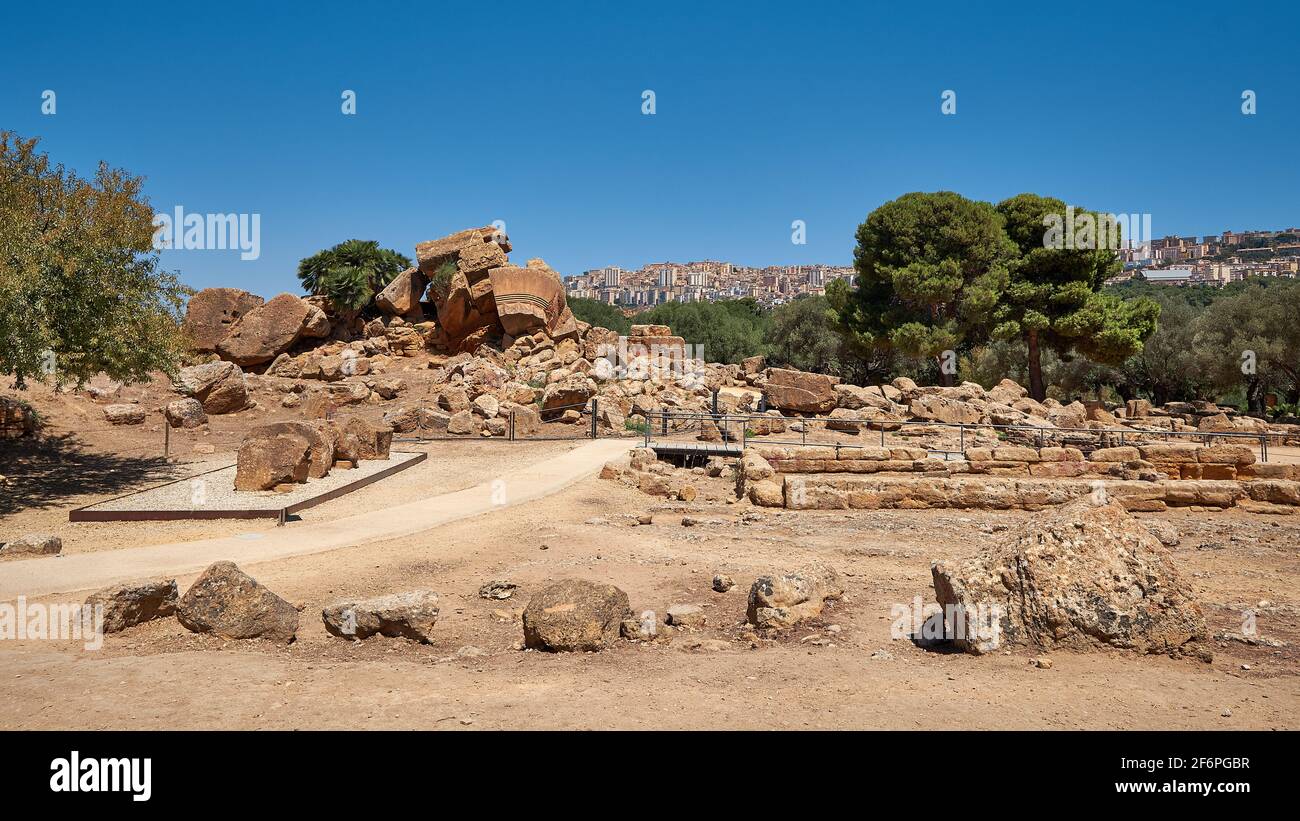 Ancient stones and broken columns. Landscape with olive trees and view ...
