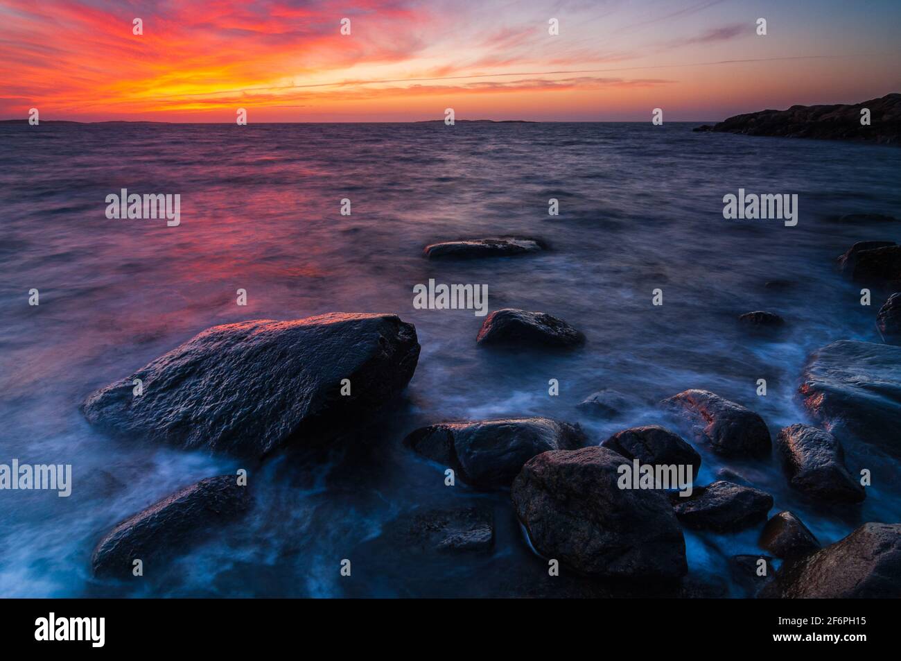 Rock in sea sunset sky cloud sky hi-res stock photography and images ...