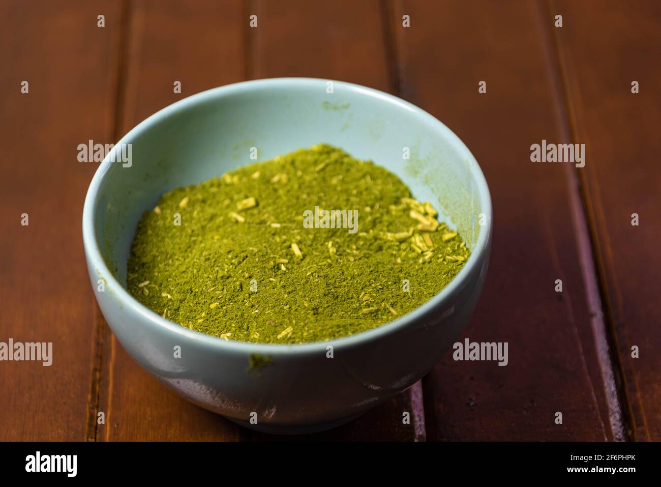 Mate herb (Ilex paraguariensis) ground in a ceramic container for ...