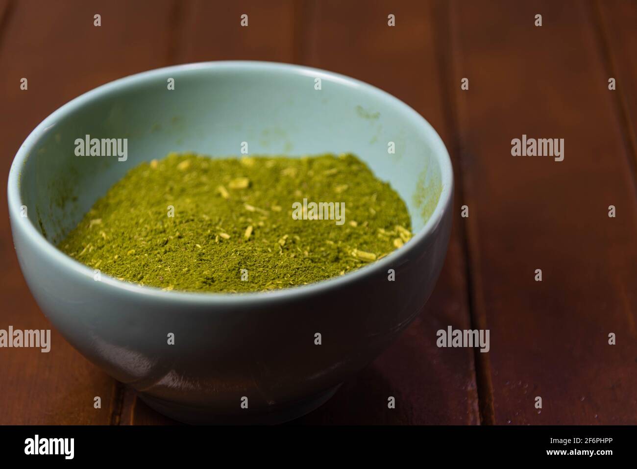 Mate herb (Ilex paraguariensis) ground in a ceramic container for ...