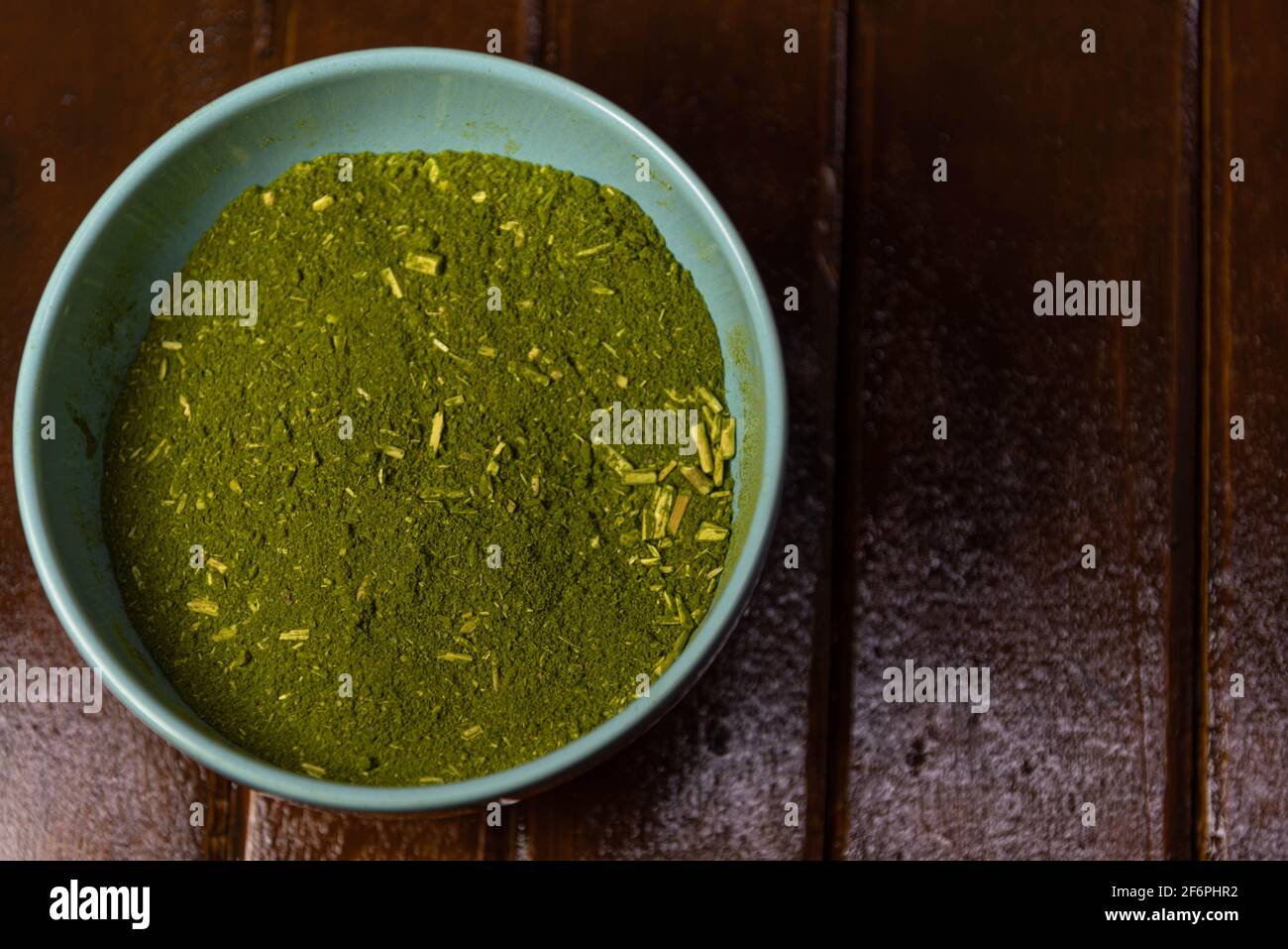 Mate herb (Ilex paraguariensis) ground in a ceramic container for ...