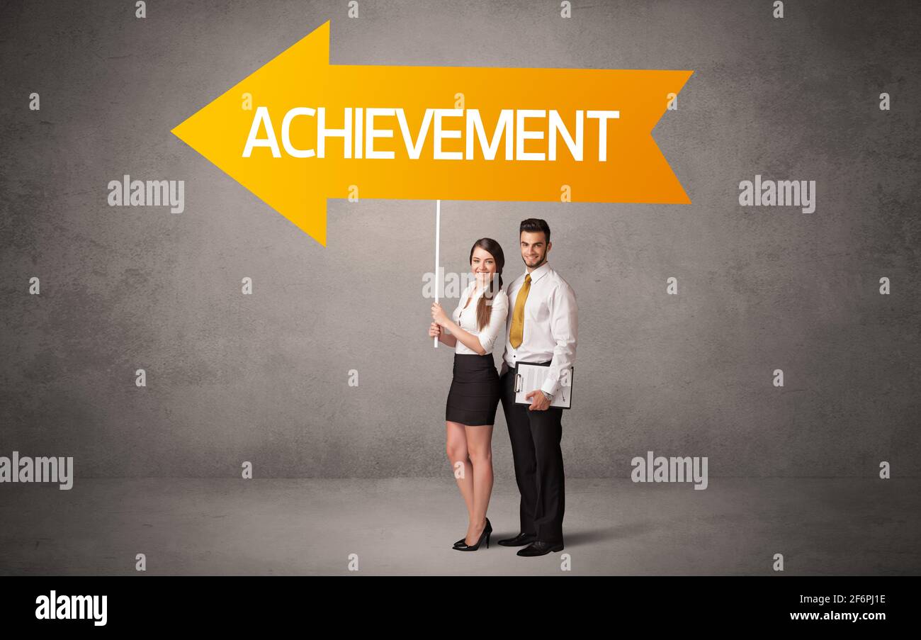 Young business person in casual holding road sign Stock Photo - Alamy