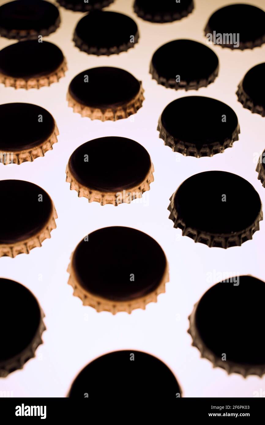 beer caps on a light background Stock Photo - Alamy