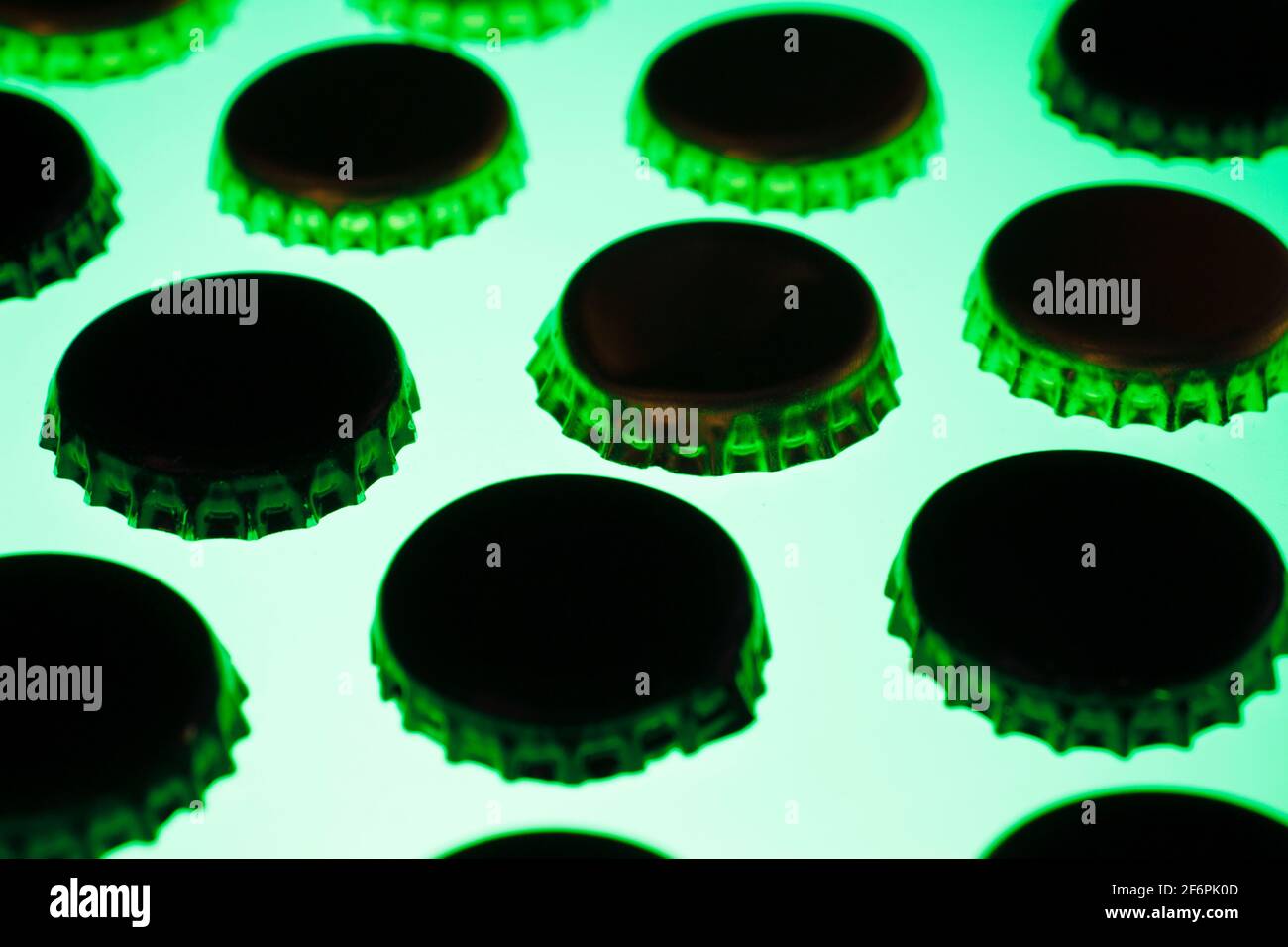 beer caps on green background Stock Photo - Alamy