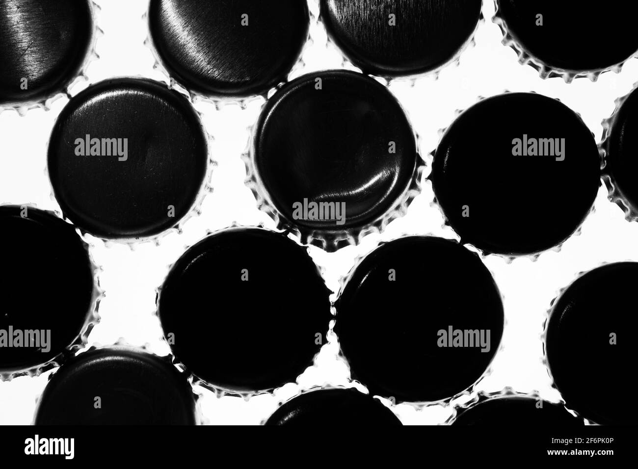 black beer caps on white background Stock Photo - Alamy
