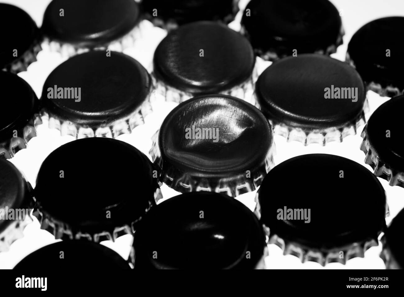 black beer caps on white background Stock Photo - Alamy