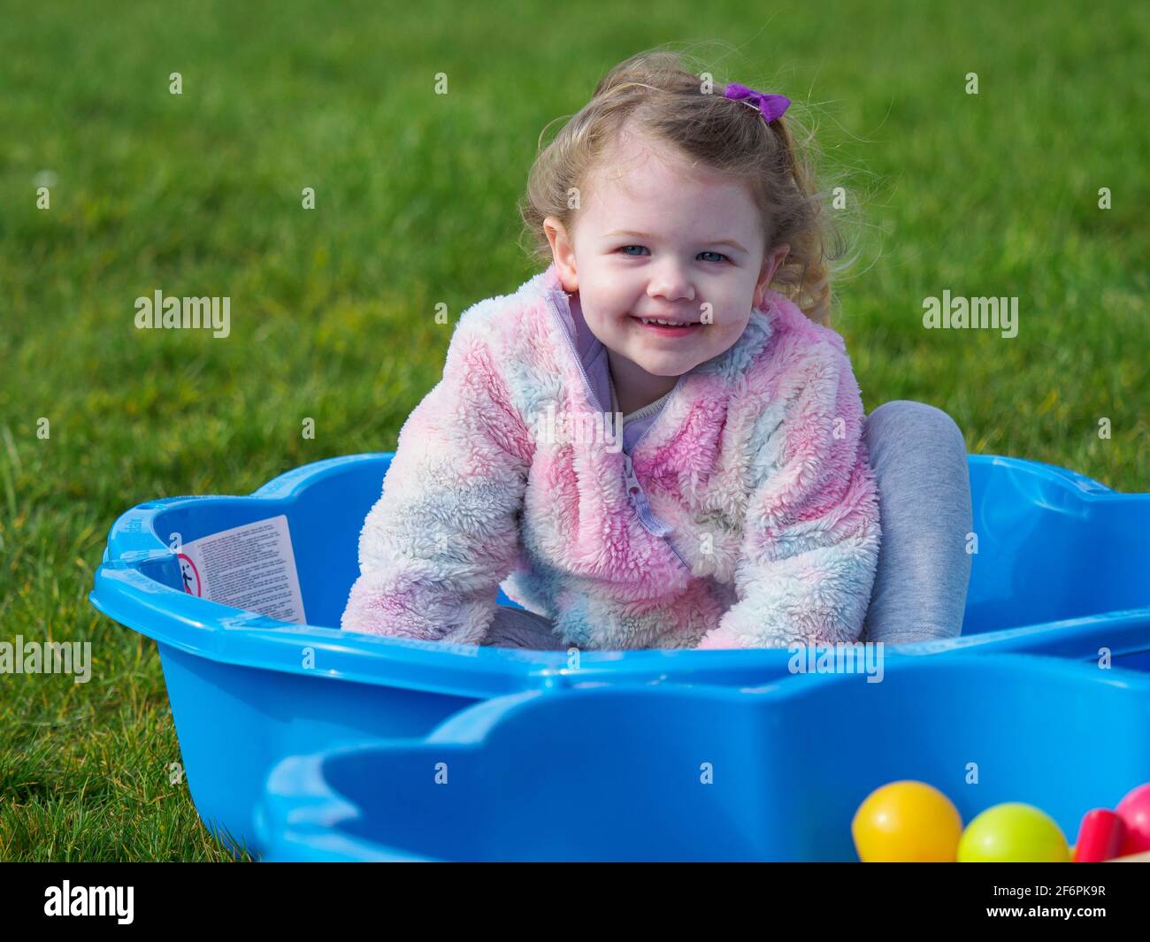 Toddler sat in sand pit playing, UK Stock Photo - Alamy