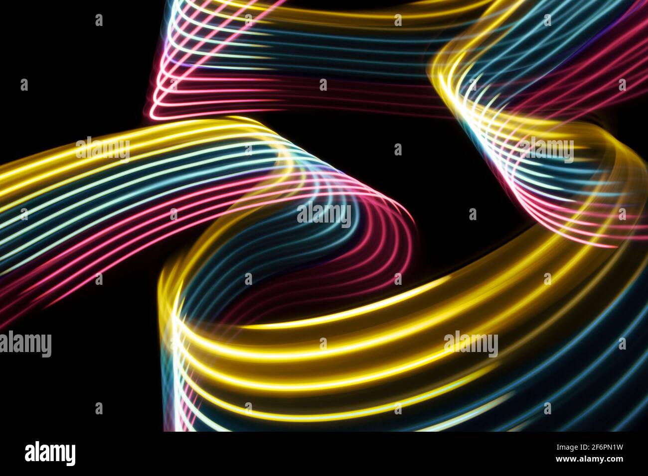Yellow, pink and blue light curve lines on a black background Stock ...
